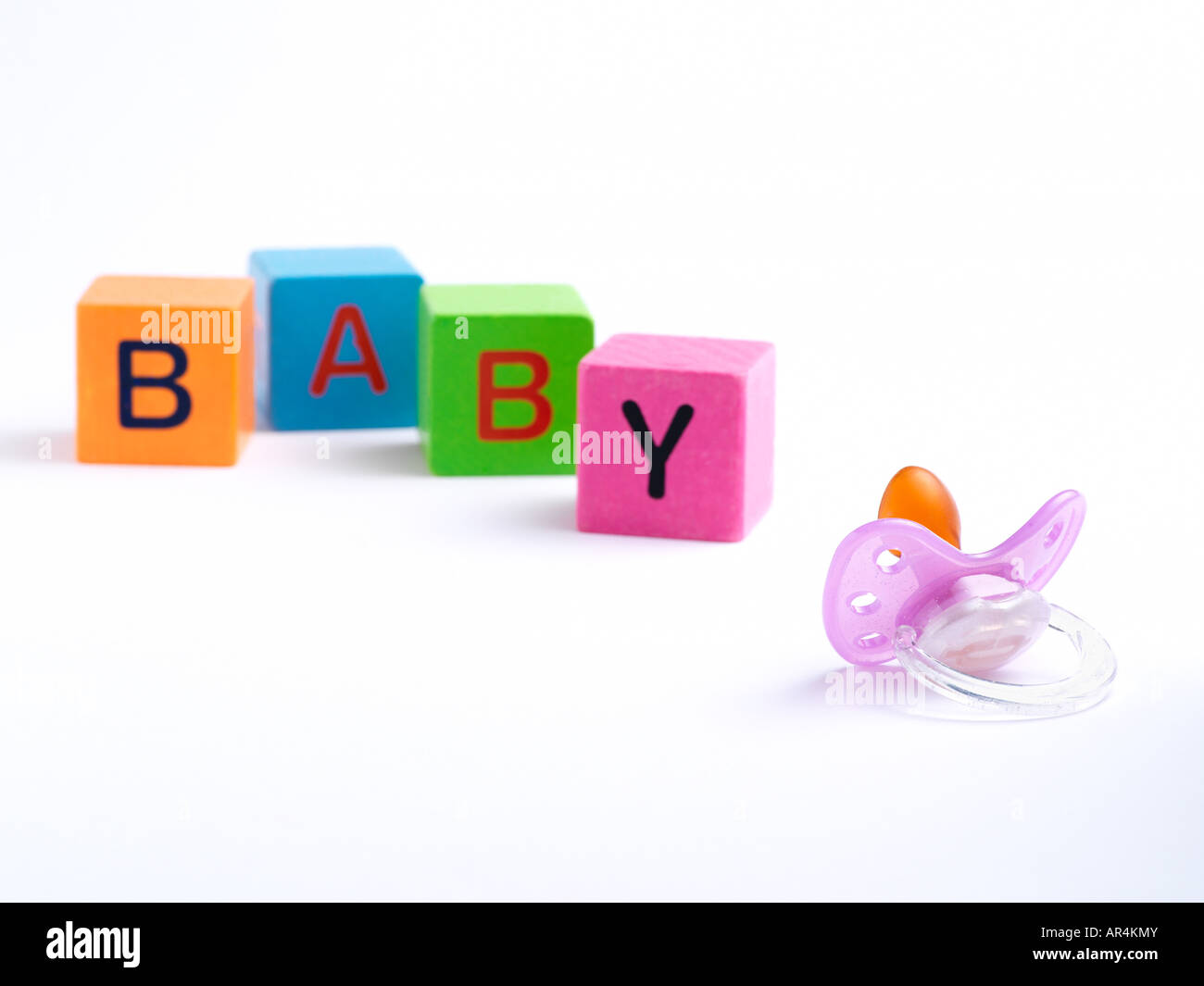 Dummy and building blocks spelling baby Stock Photo - Alamy