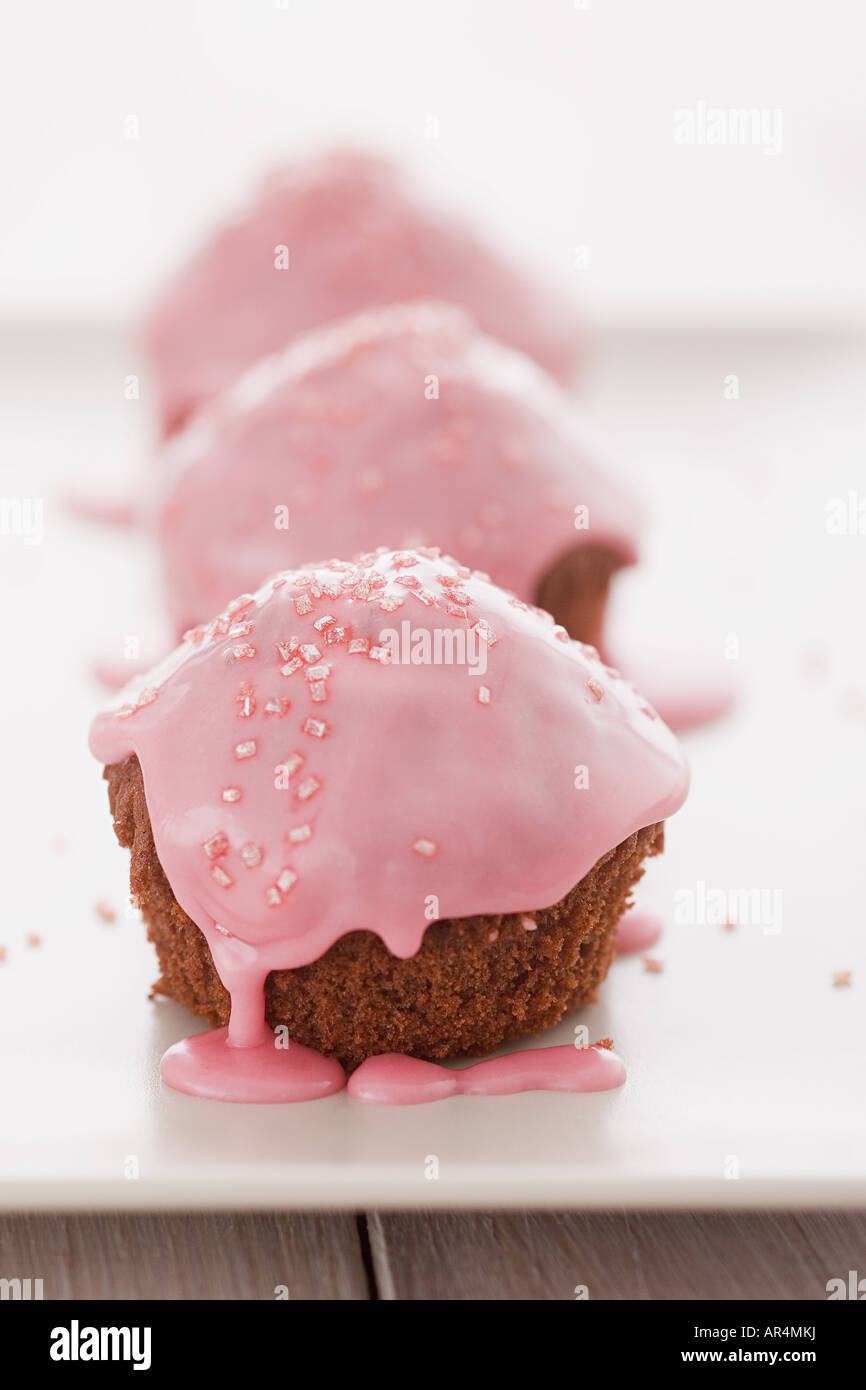 Cakes covered in pink icing Stock Photo - Alamy