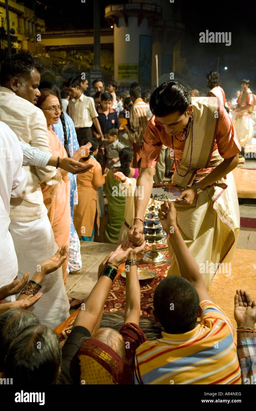 Brahman giving prasad blessing. Ganga aarti ceremony. Dasaswamedh Ghat ...