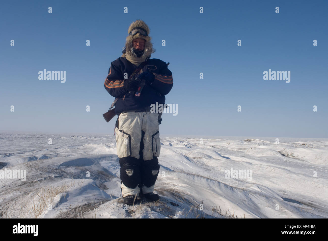 inupiat hunter scouts the landscape for wildlife along the Arctic coast ...