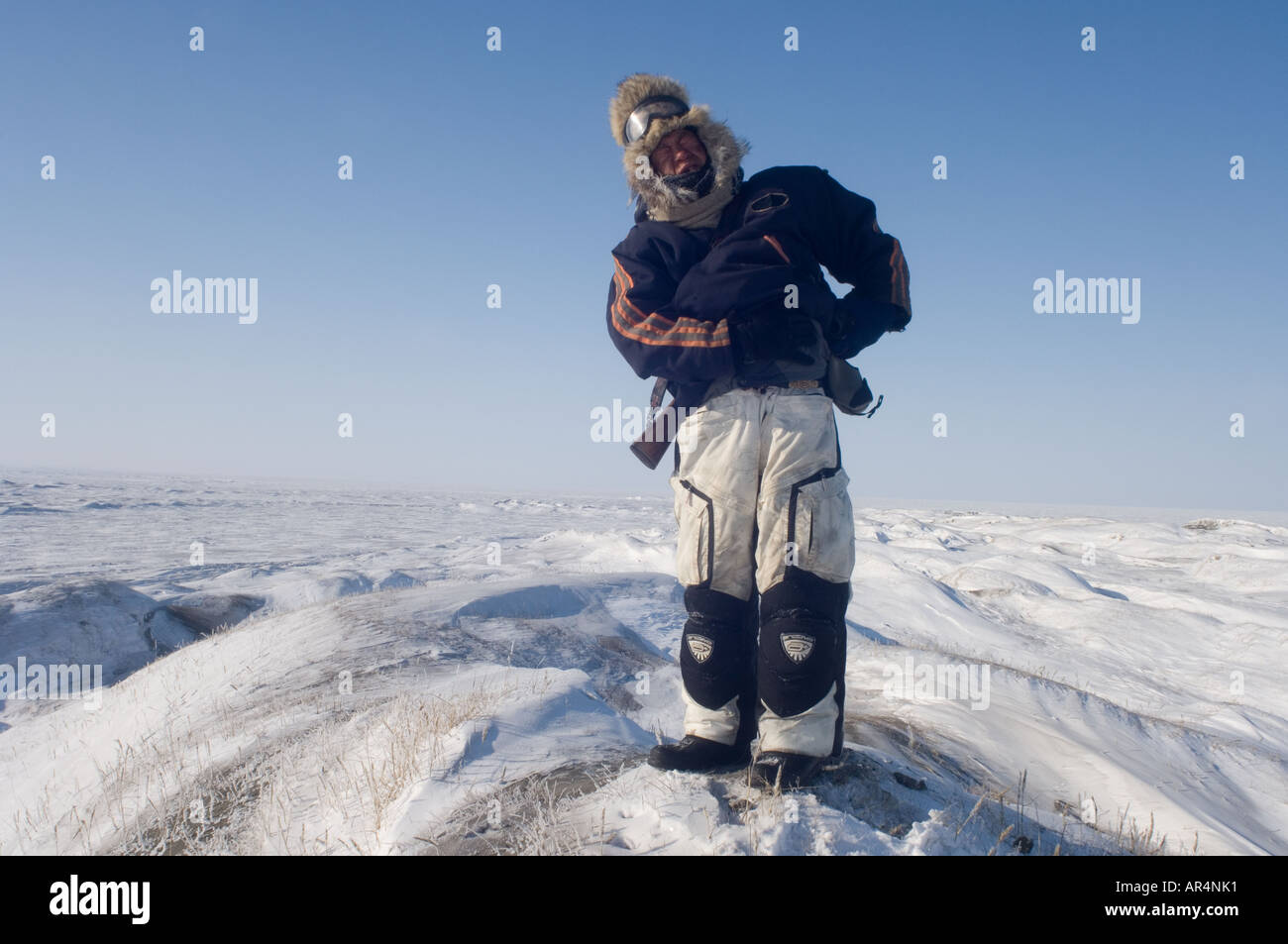 inupiat hunter scouts the landscape for wildlife along the Arctic coast ...