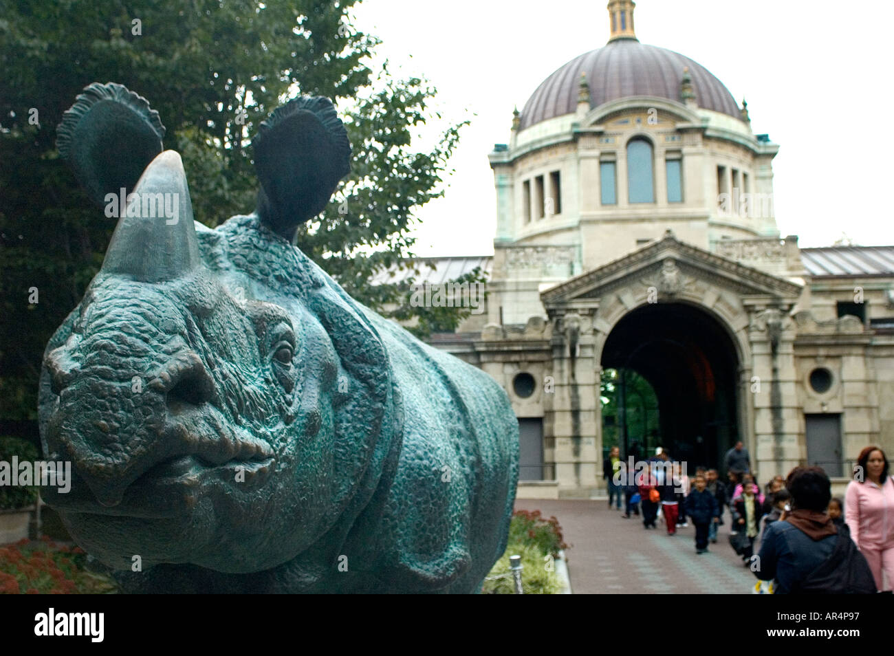 Sculpted rhinoceros and guests on the grounds at the Bronx Zoo in New ...
