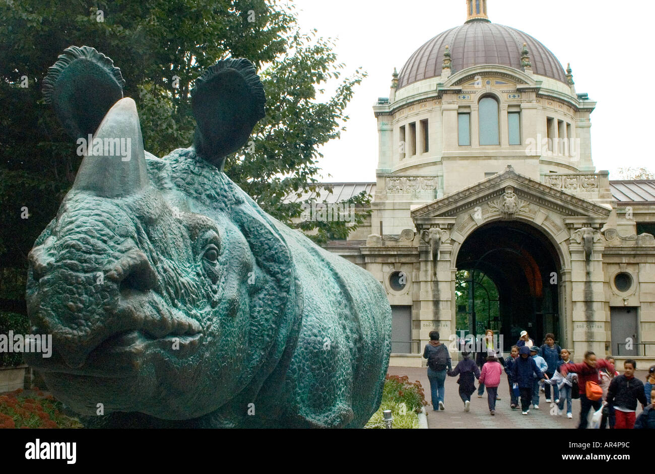 Sculpted rhinoceros and guests on the grounds at the Bronx Zoo in New ...