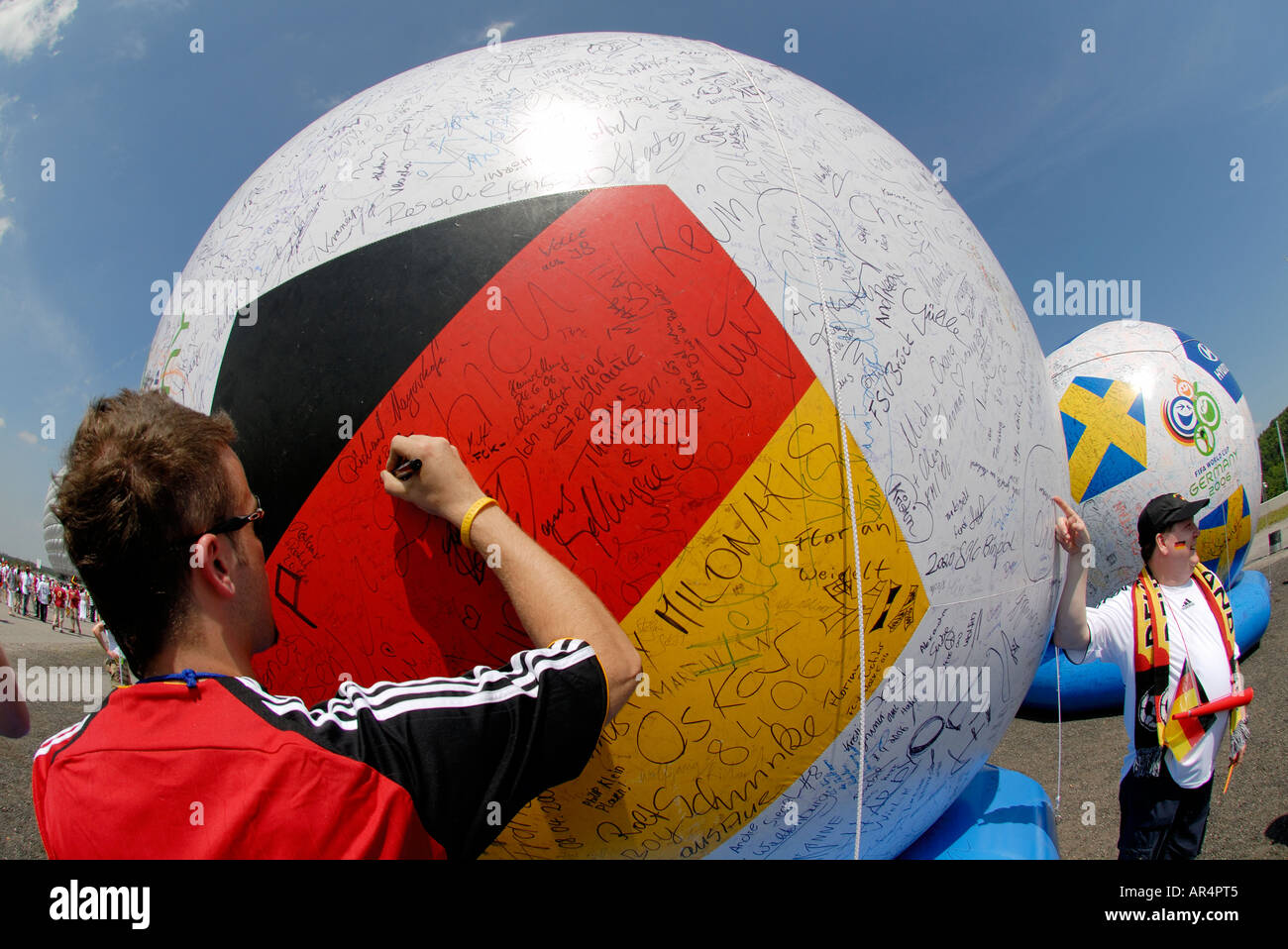 fans sign giant football Stock Photo - Alamy