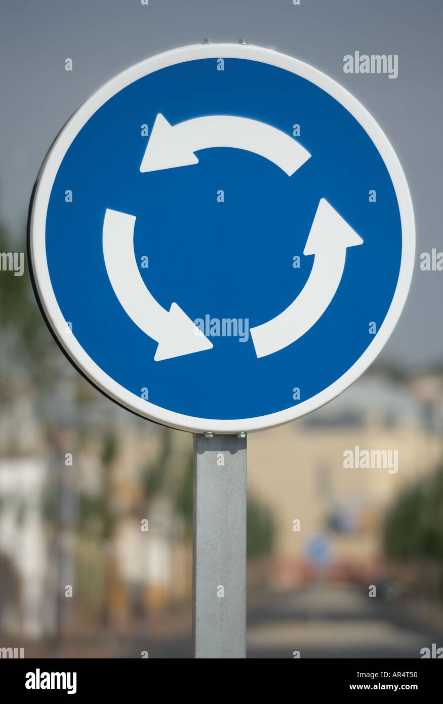 Arrows on traffic sign showing direction to drive on roundabout Stock ...