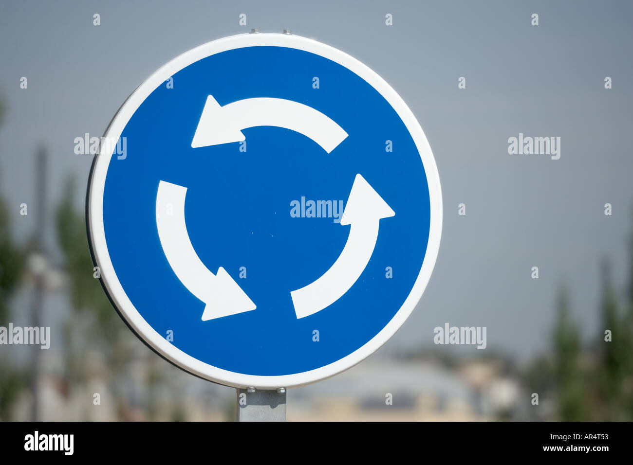 Arrows on traffic sign showing direction to drive on roundabout Stock ...