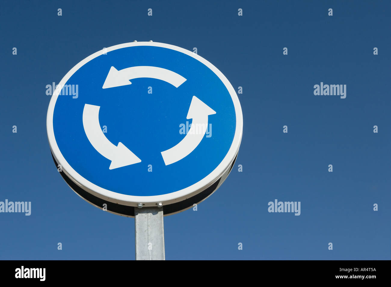 Arrows on traffic sign showing direction to drive on roundabout Stock ...