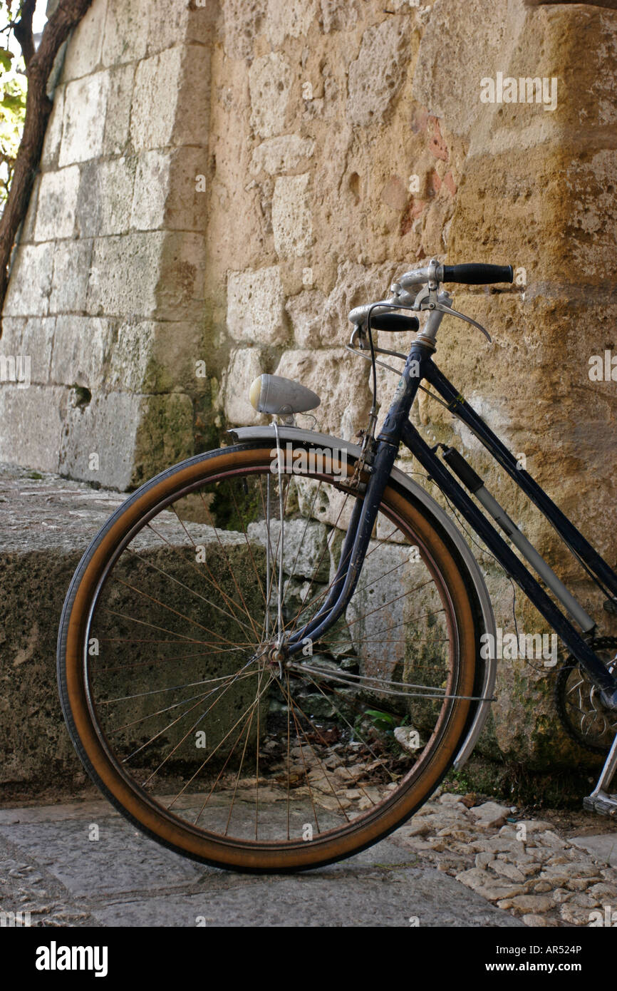 Bike against wall Stock Photo - Alamy