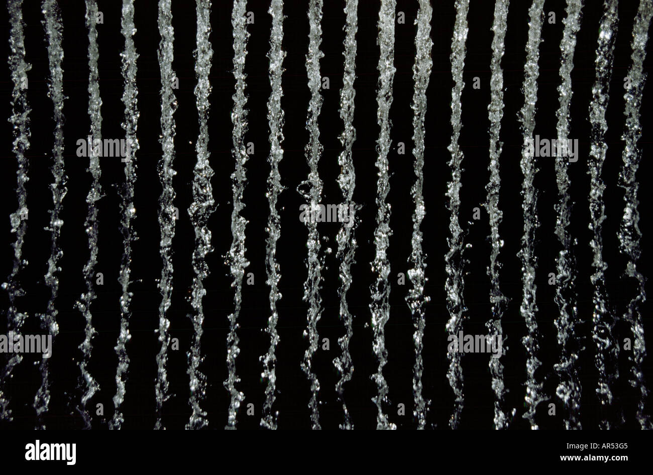 Abstract image of lines of running water against a black background ...