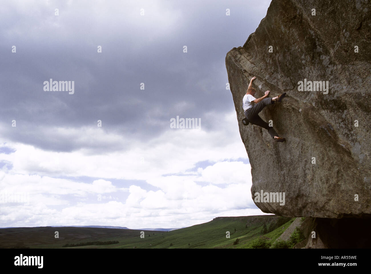 A climber working his way up the ramp of the Grand Hotel boulder at ...