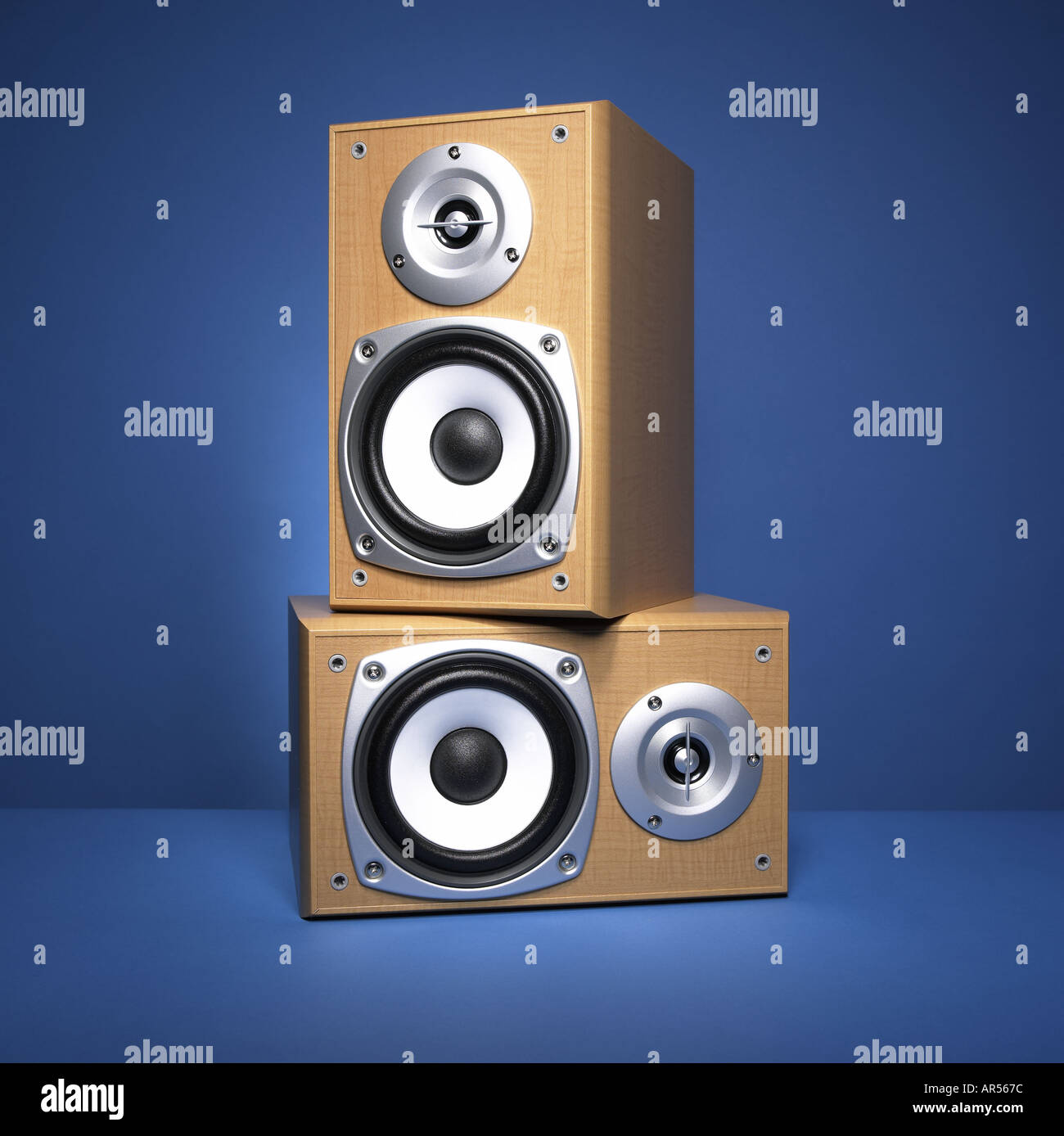 two hifi speakers on a blue background one stacked on the other Stock ...