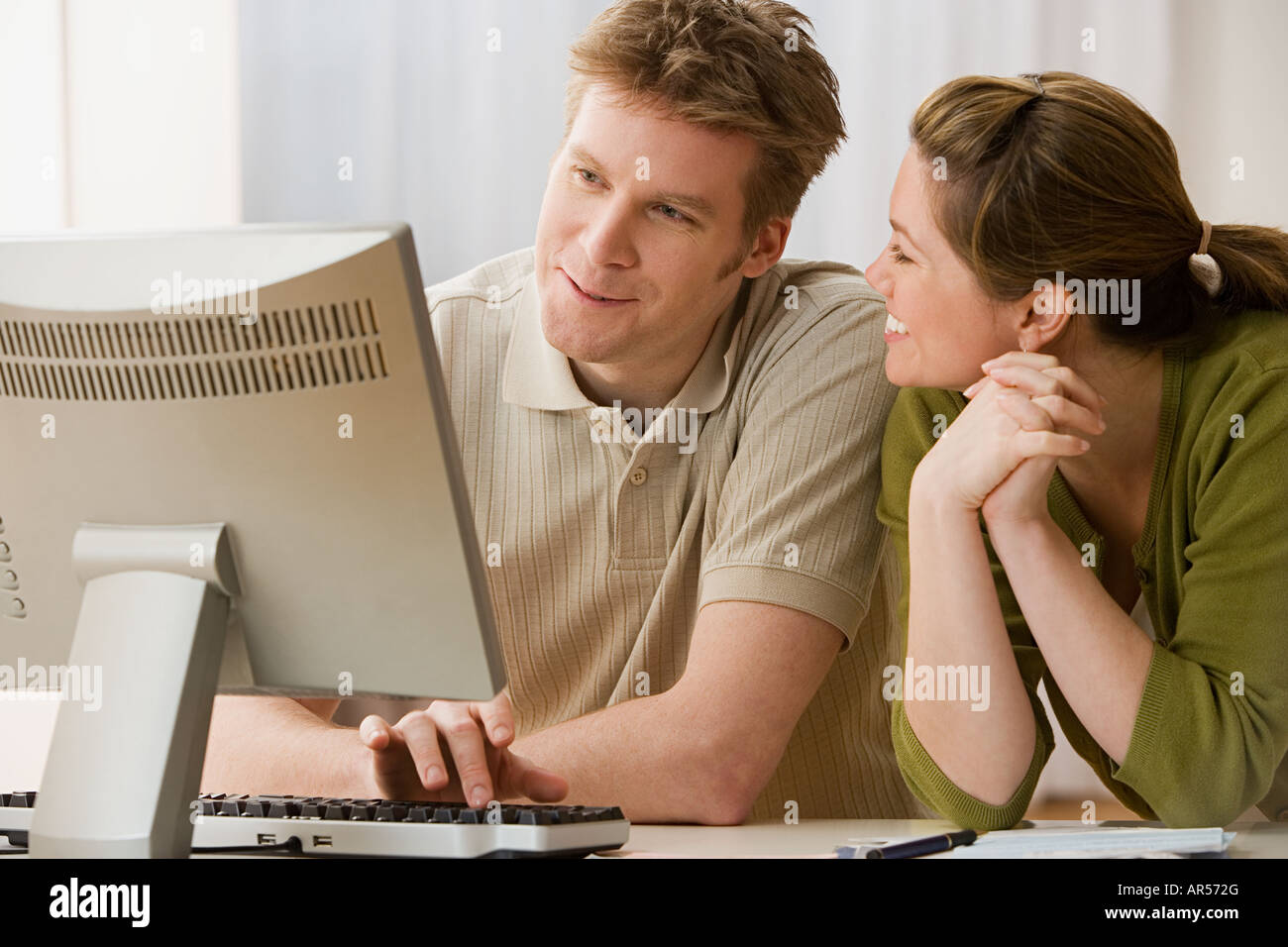 Couple using computer Stock Photo - Alamy