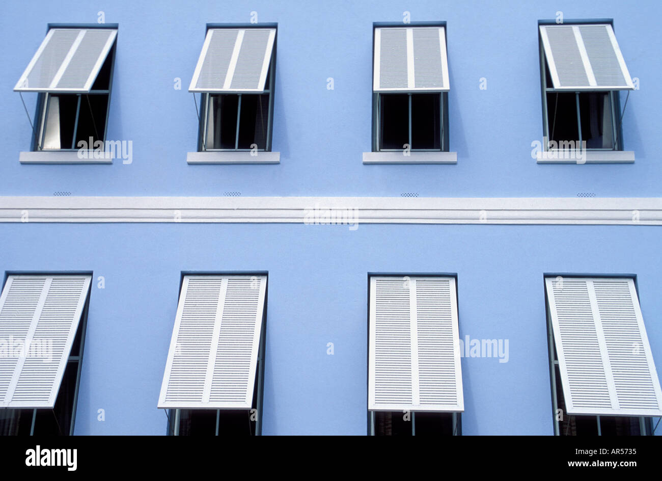 Pastel blue building exterior with white shutters hi-res stock ...