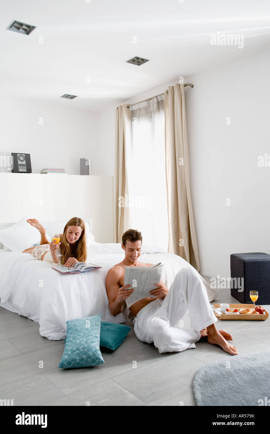 Couple reading in bedroom Stock Photo - Alamy