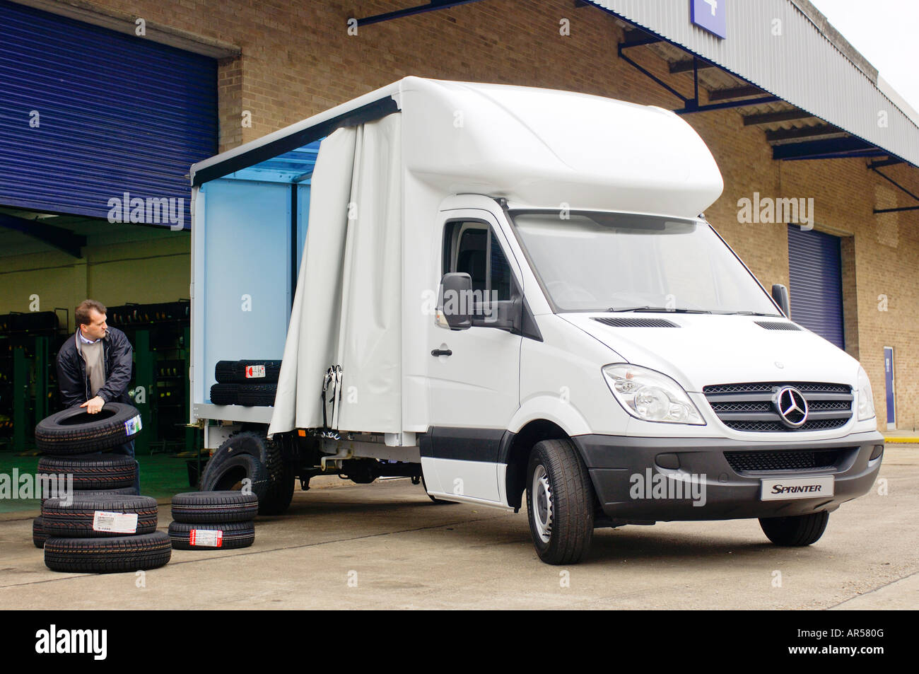 Mercedes Benz Sprinter Luton curtain sided truck being loaded with ...