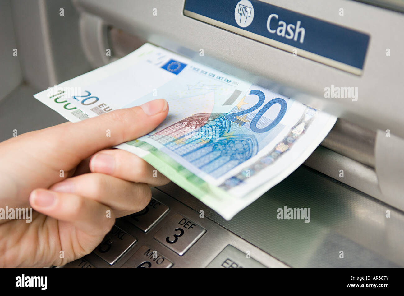Person withdrawing cash Stock Photo - Alamy