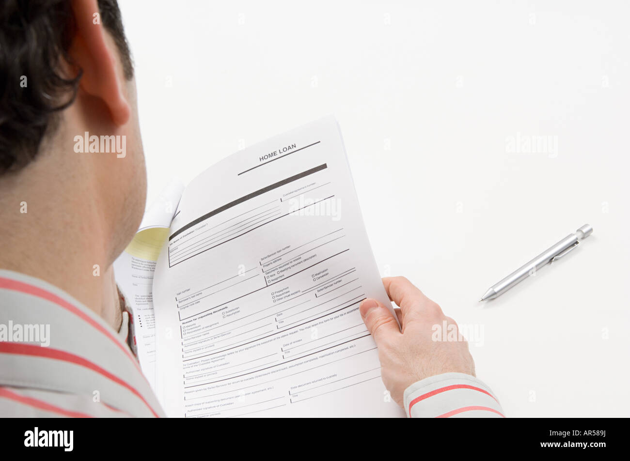 Man reading paperwork Stock Photo - Alamy