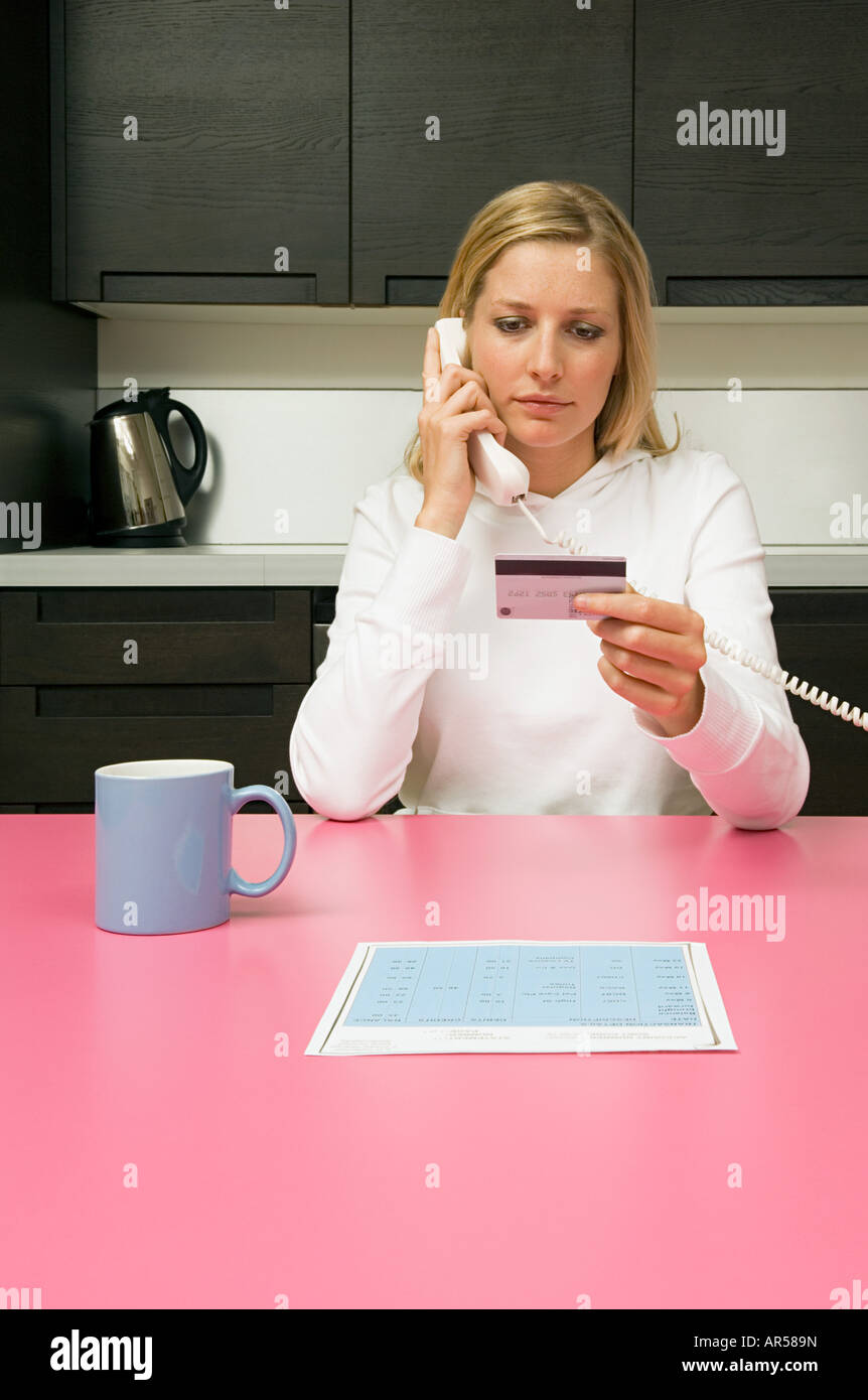 Woman telephone banking Stock Photo - Alamy
