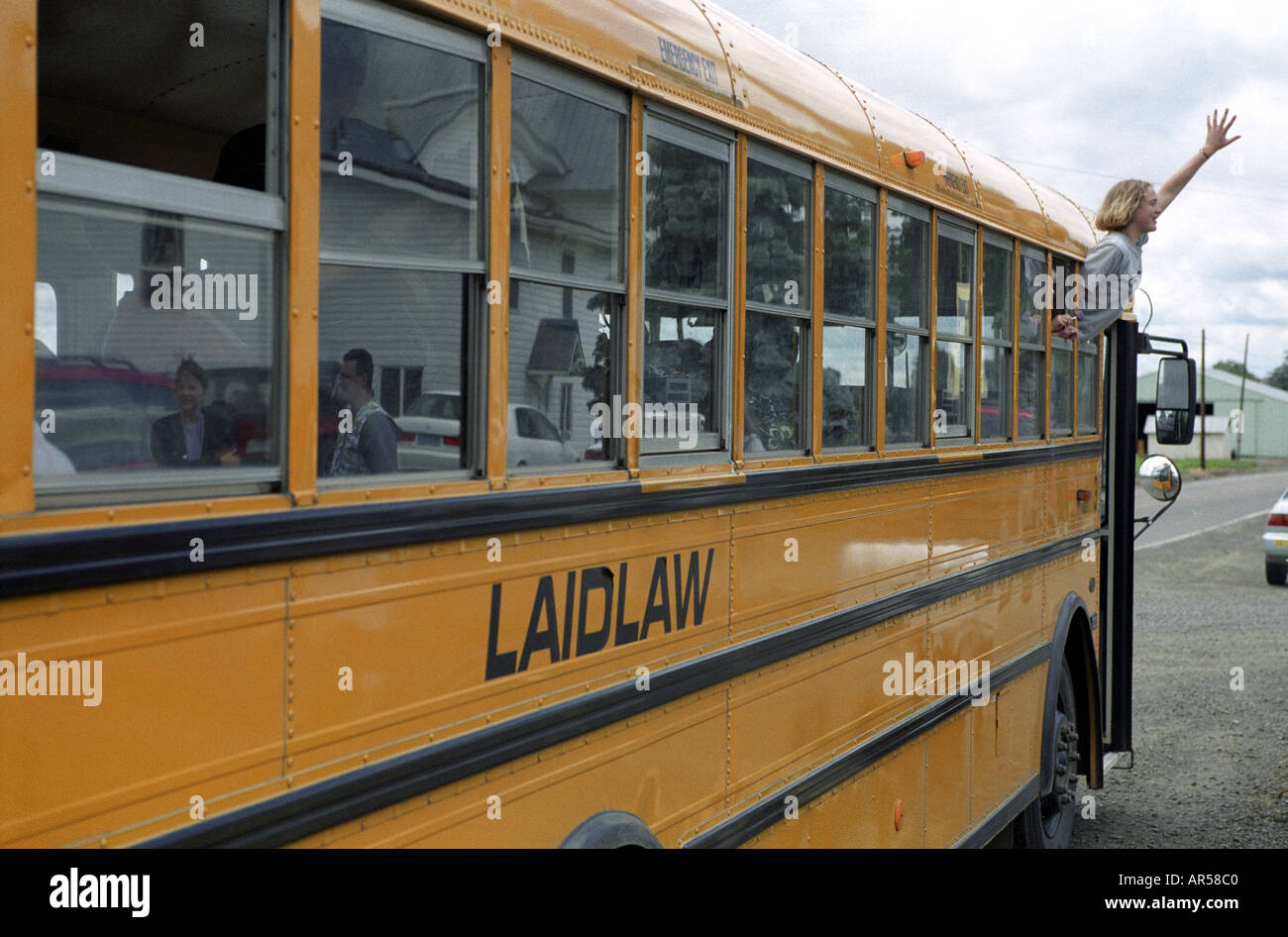 Student waves out of window of bus on last day of school Stock Photo ...