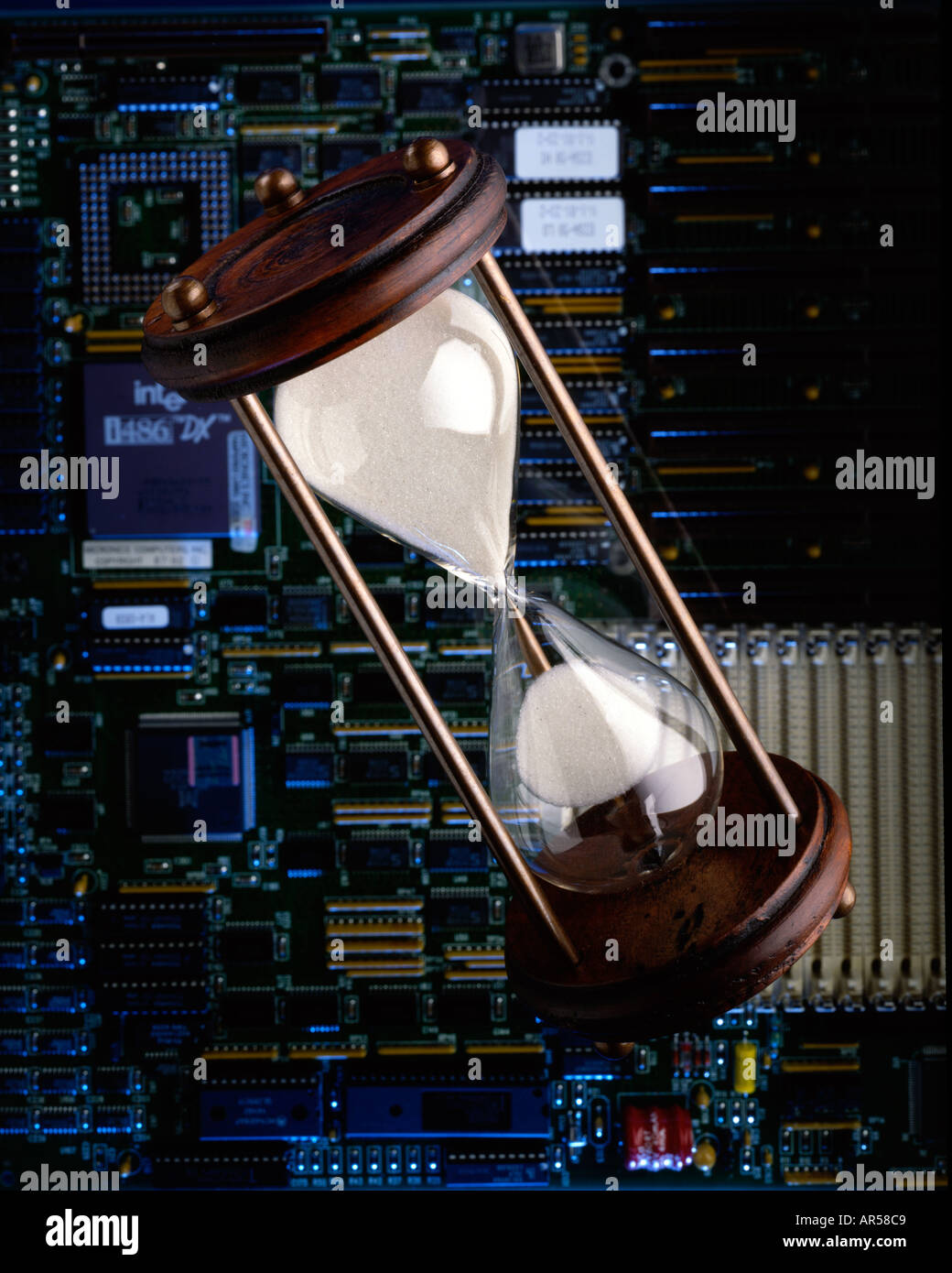 Hourglass timer against a computer motherboard Stock Photo - Alamy