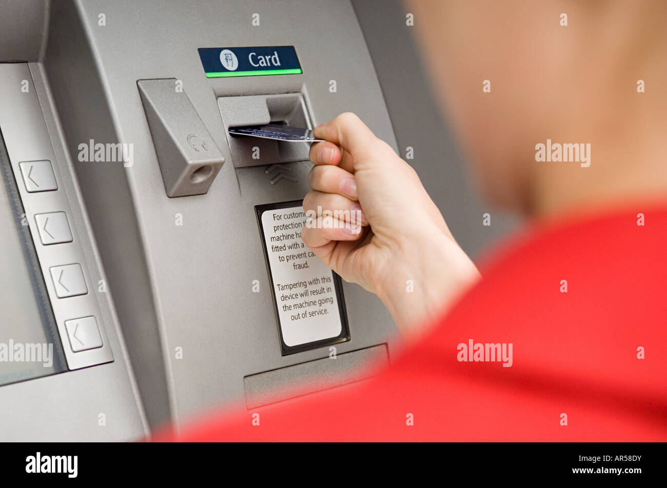 Person using cash machine Stock Photo - Alamy