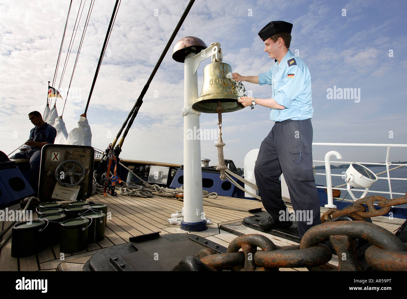 A sailor cleaning the ships bell on the training ship Gorch Fock, Kiel ...