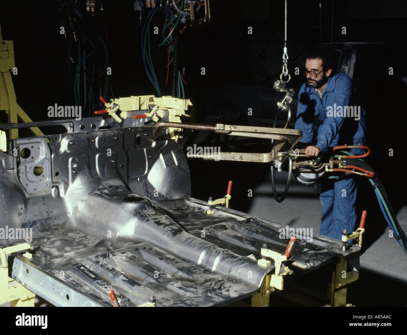 Egyptian worker welding chasis of pick up truck in assembly plant near ...