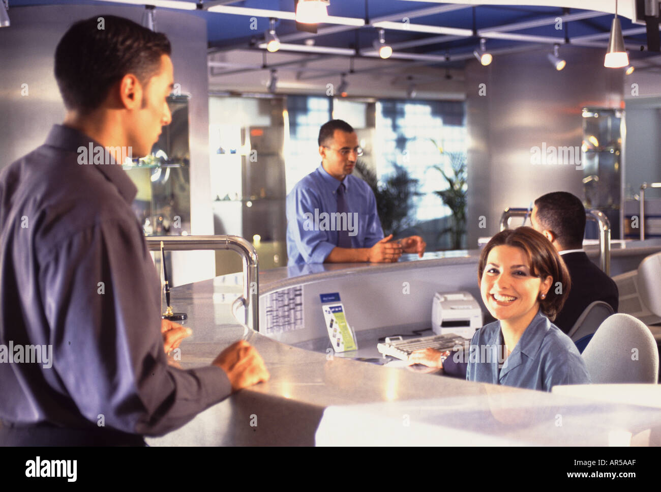 Customer service representative serving client Stock Photo - Alamy