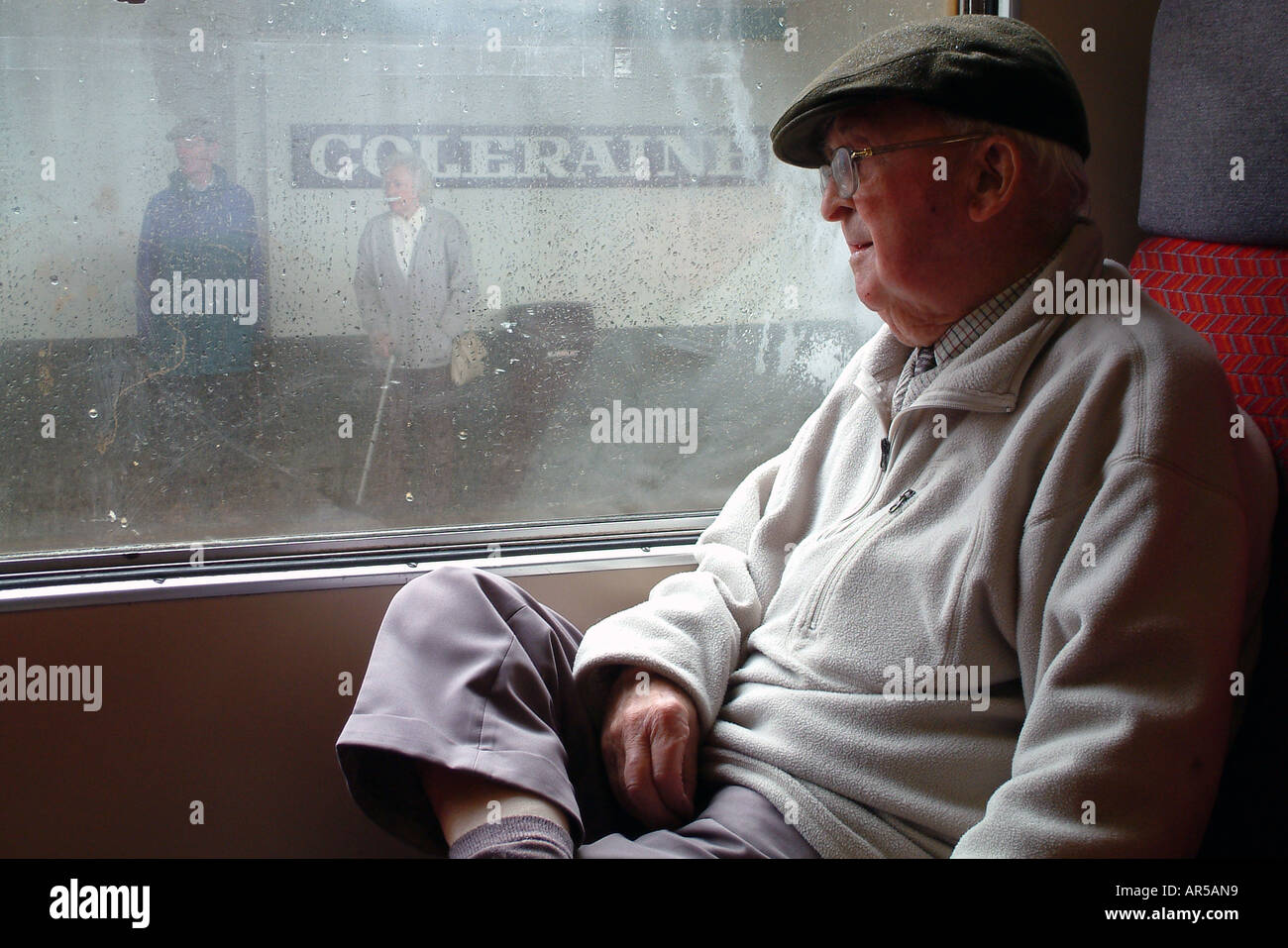 Elderly senior man looking out of train window Stock Photo - Alamy