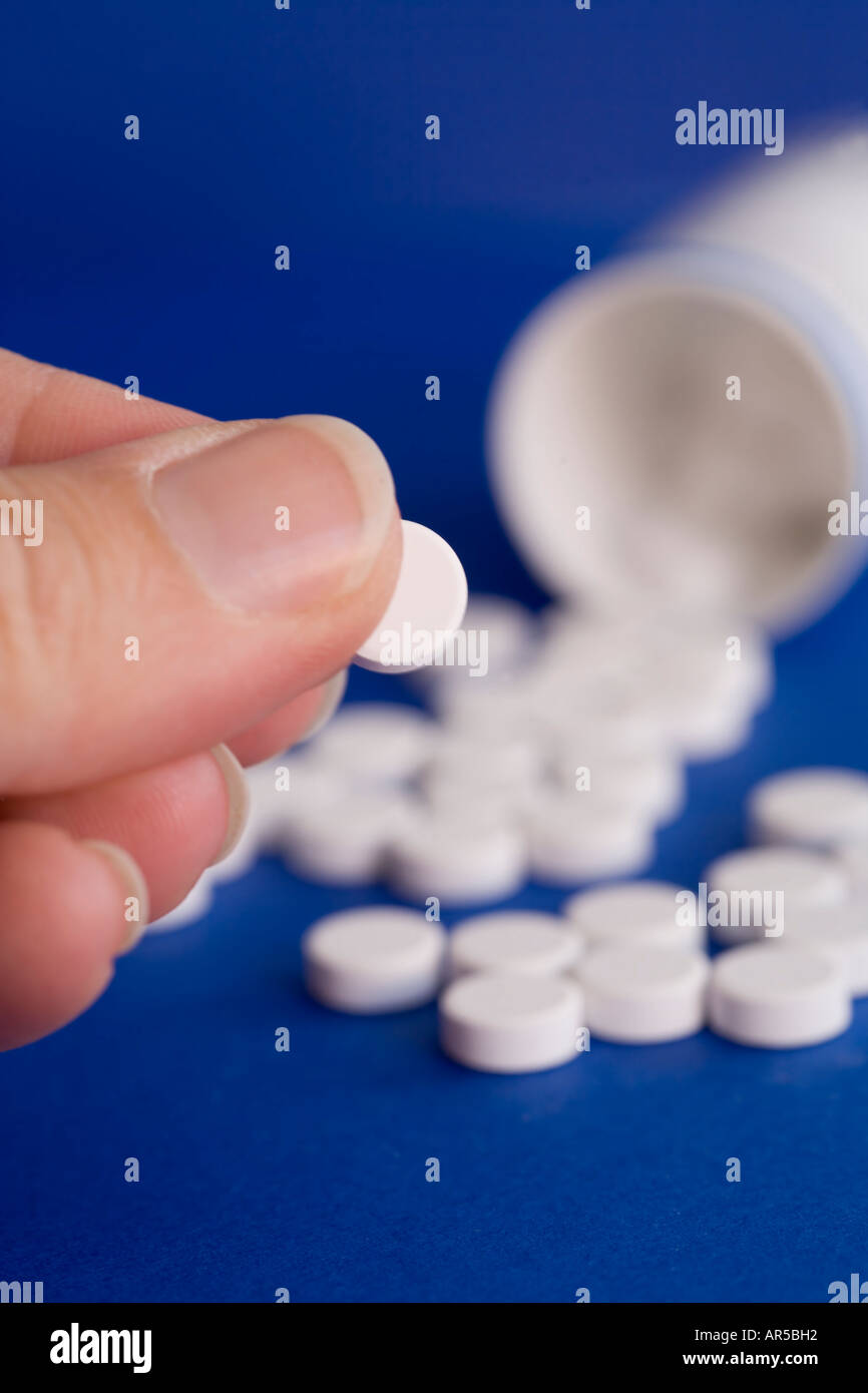 Finger holding prescription pill hi-res stock photography and images ...
