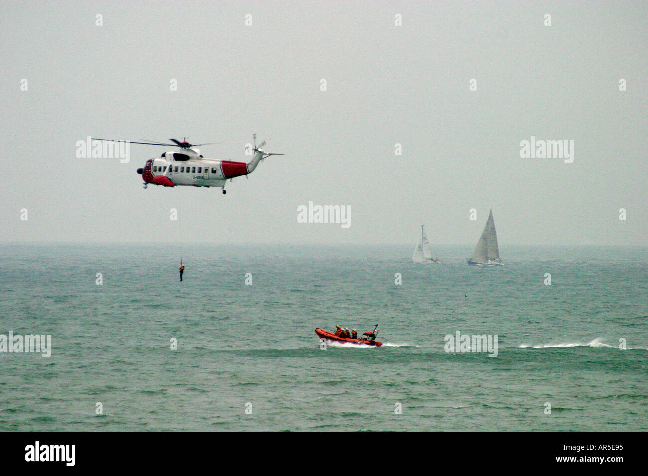 Air sea rescue helicopter with winch and lifeboat Stock Photo - Alamy