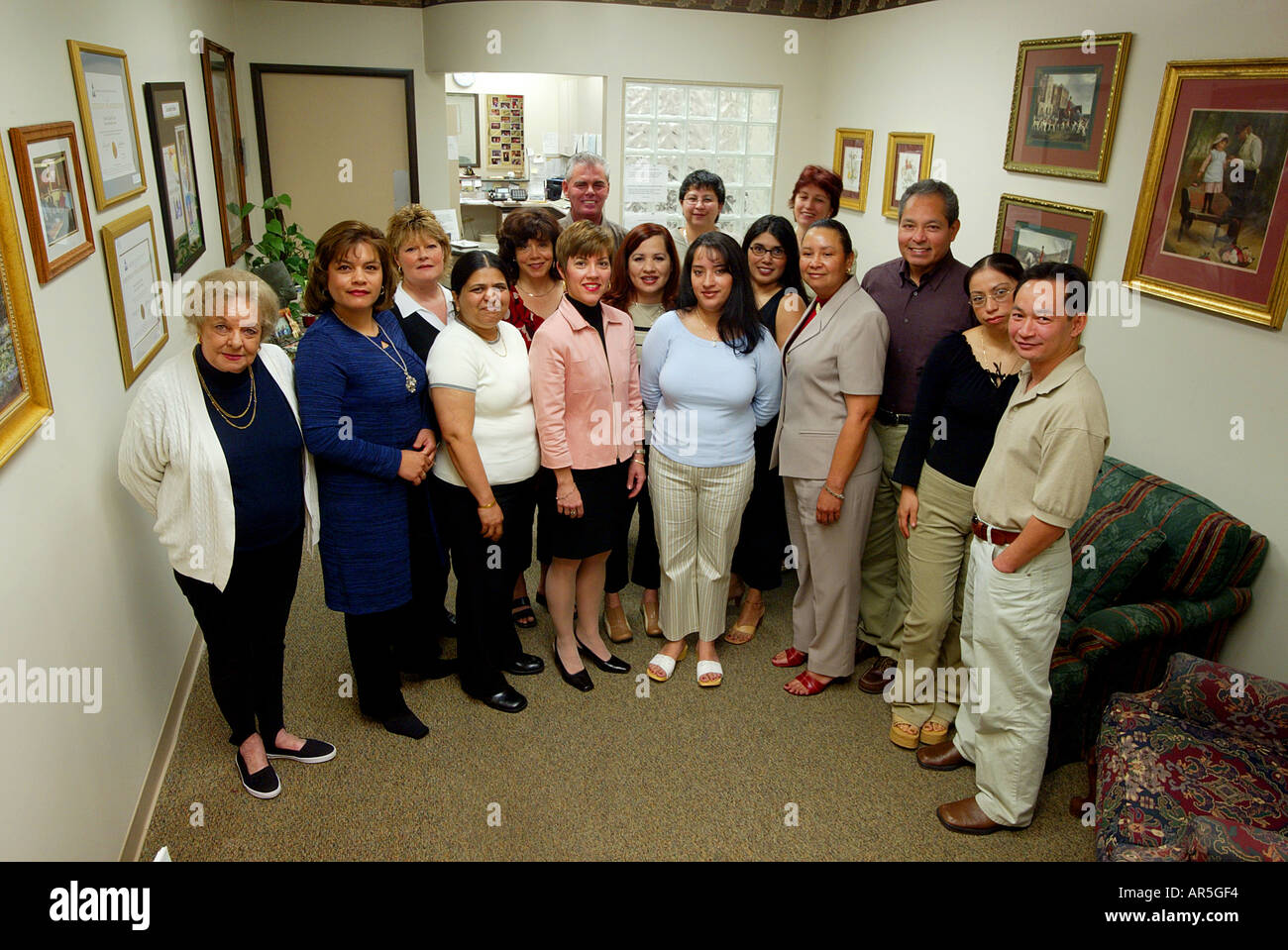 The staff of a fertility clinic poses in the waiting room of their ...