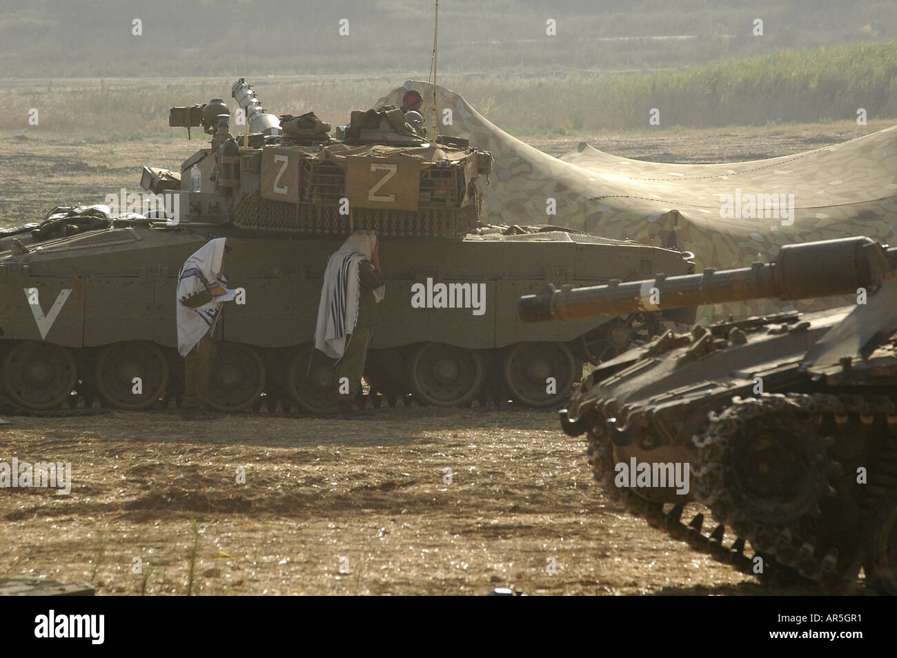 Religious IDF soldiers at prayer in tank compound, Israel Stock Photo ...