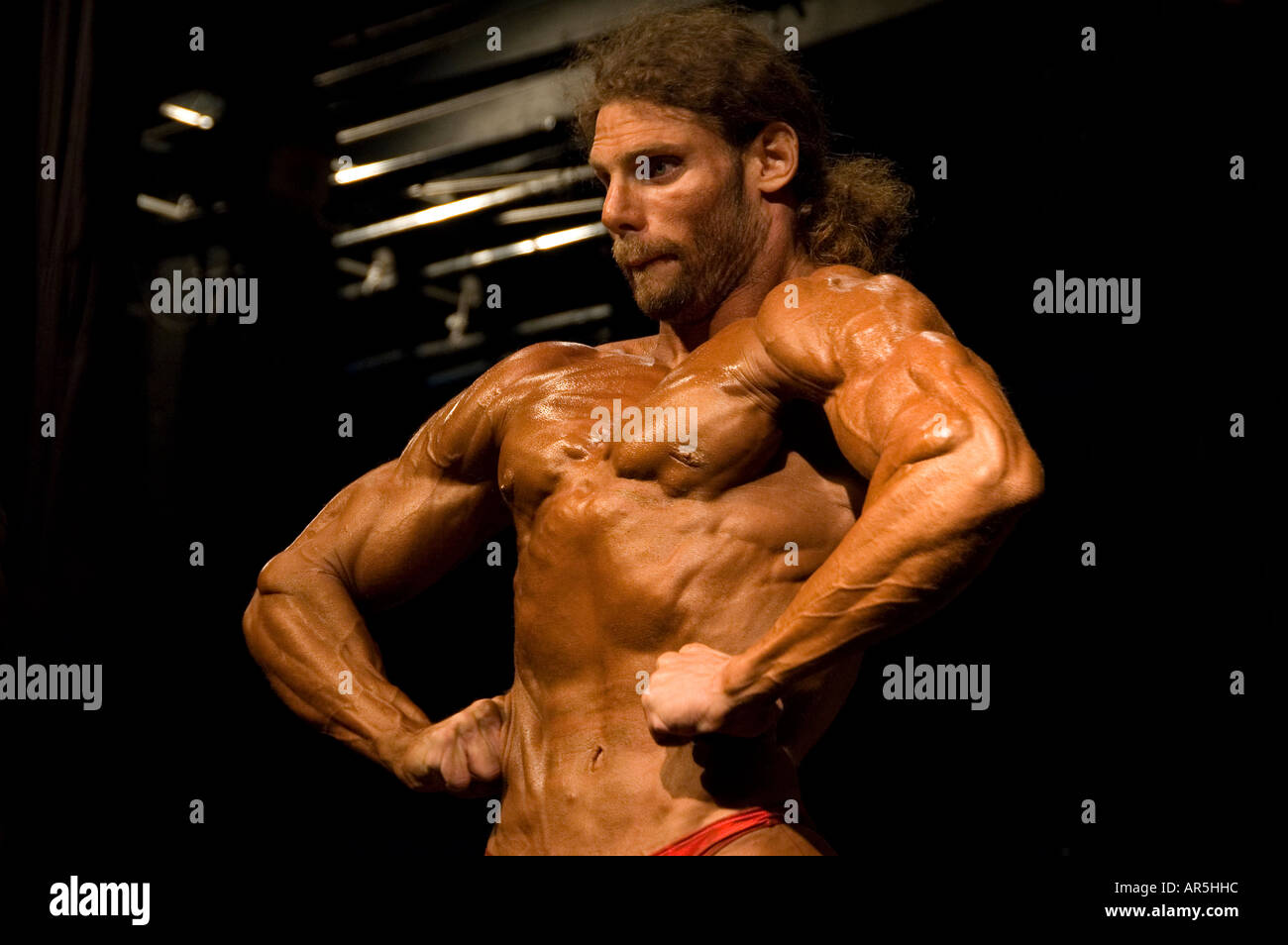 Bodybuilder performing muscular pose hi-res stock photography and ...