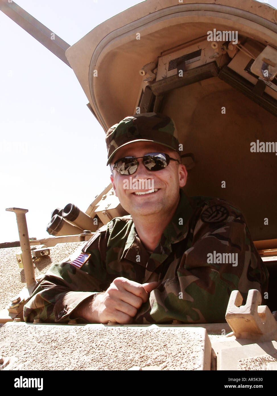 Handsome American Army Reserve soldier in tank, looking at camera and ...