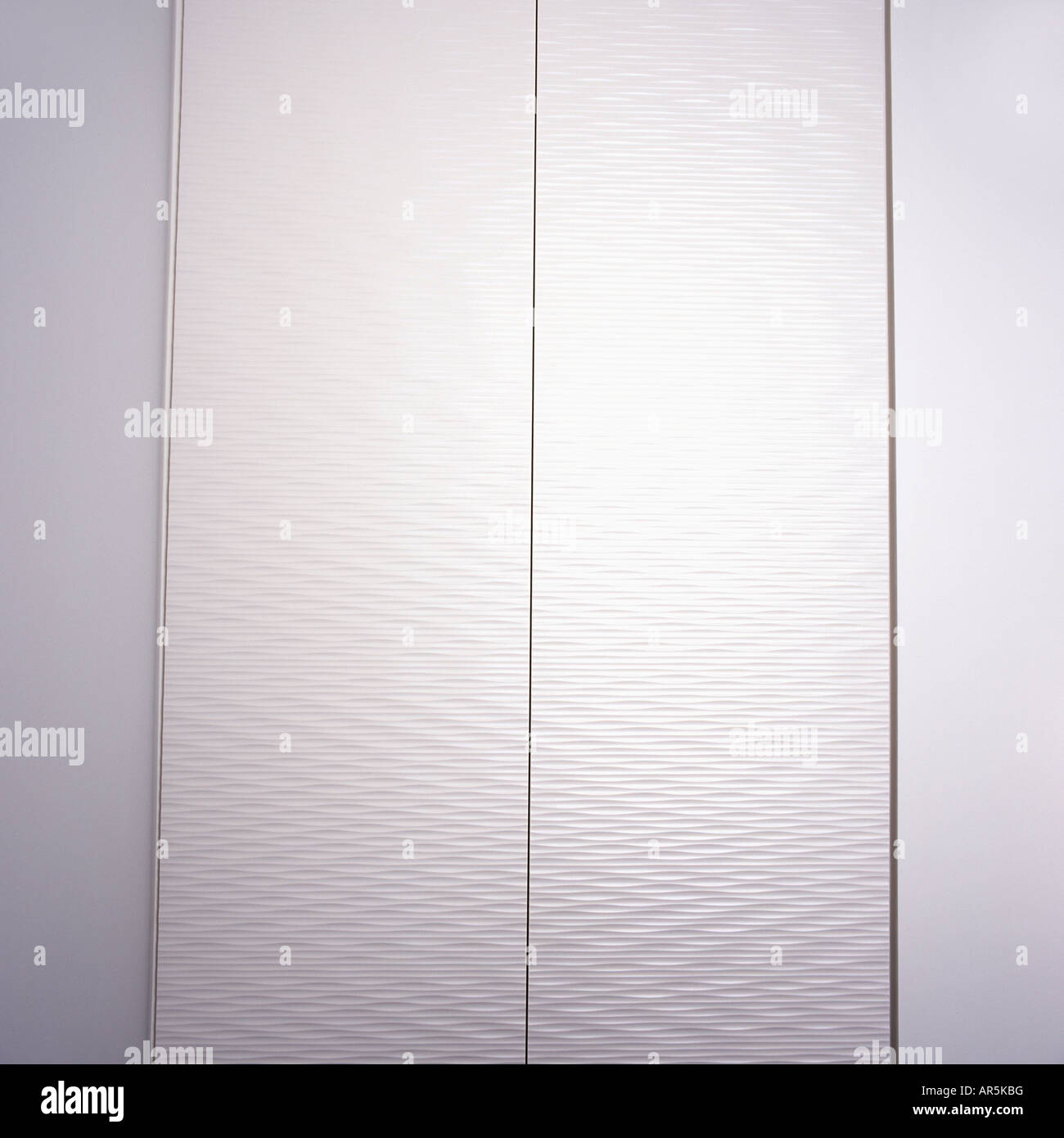 Doors closed on concealed white storage cupboard in alcove Stock Photo ...