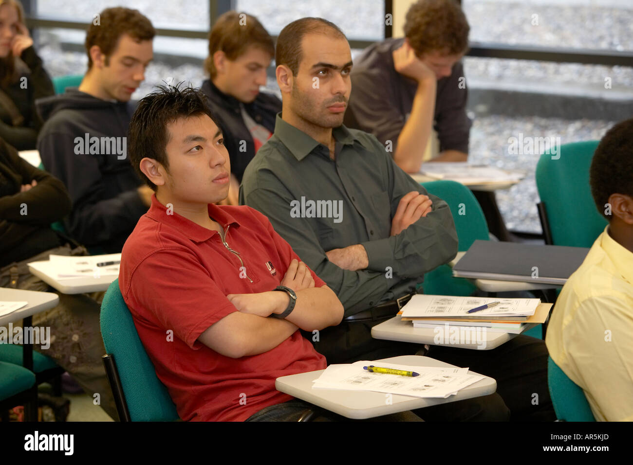 University students in classroom with arms folded Stock Photo - Alamy