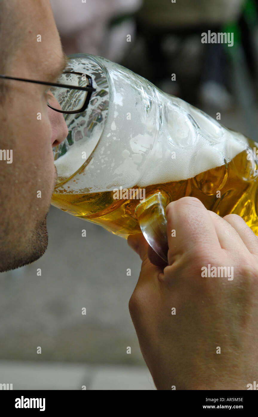 Tourist drinking a beer stein (mass), Beer garden in Englischer Garten ...