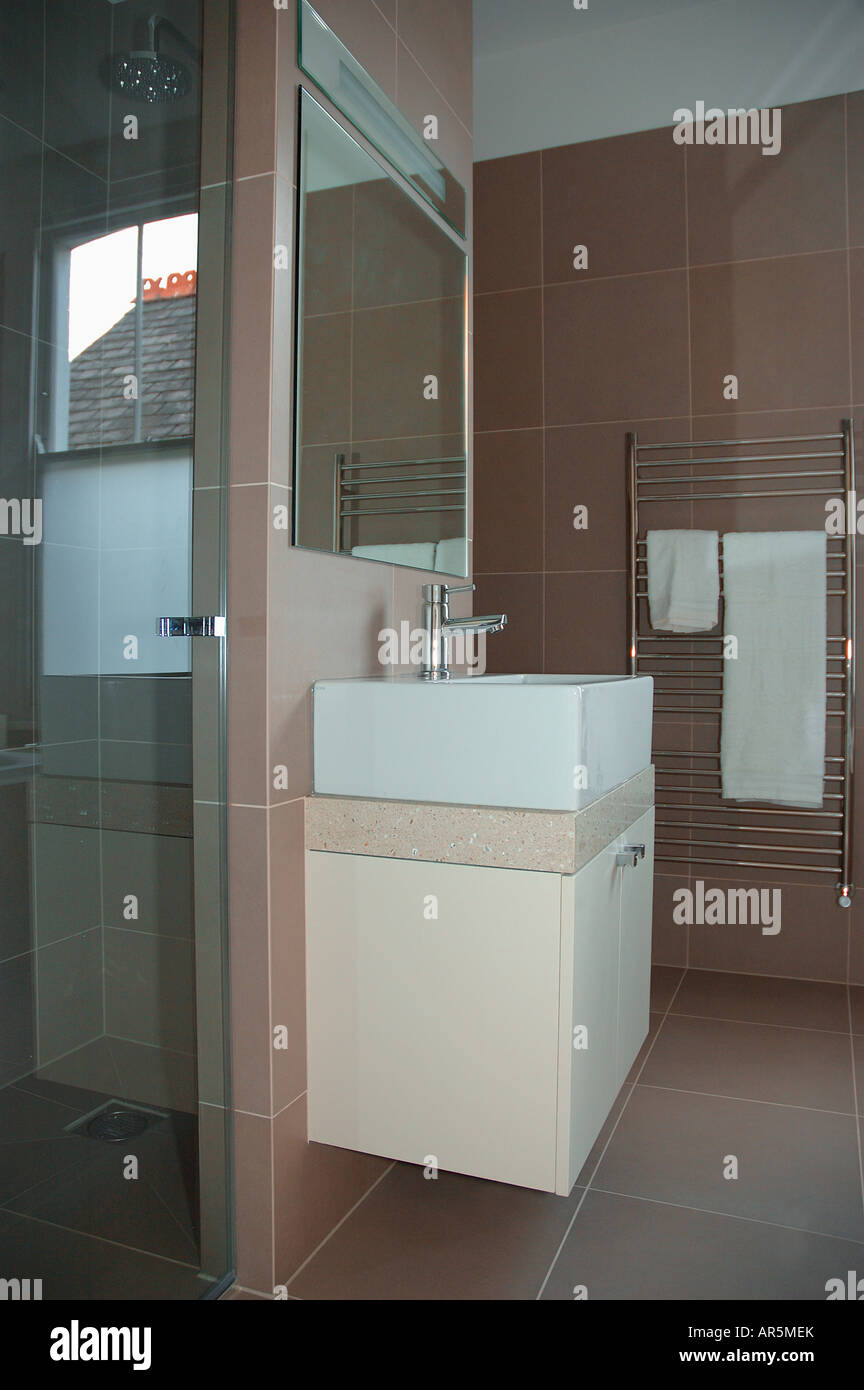 Sideways view of large mirror above wall mounted rectangular basin in ...