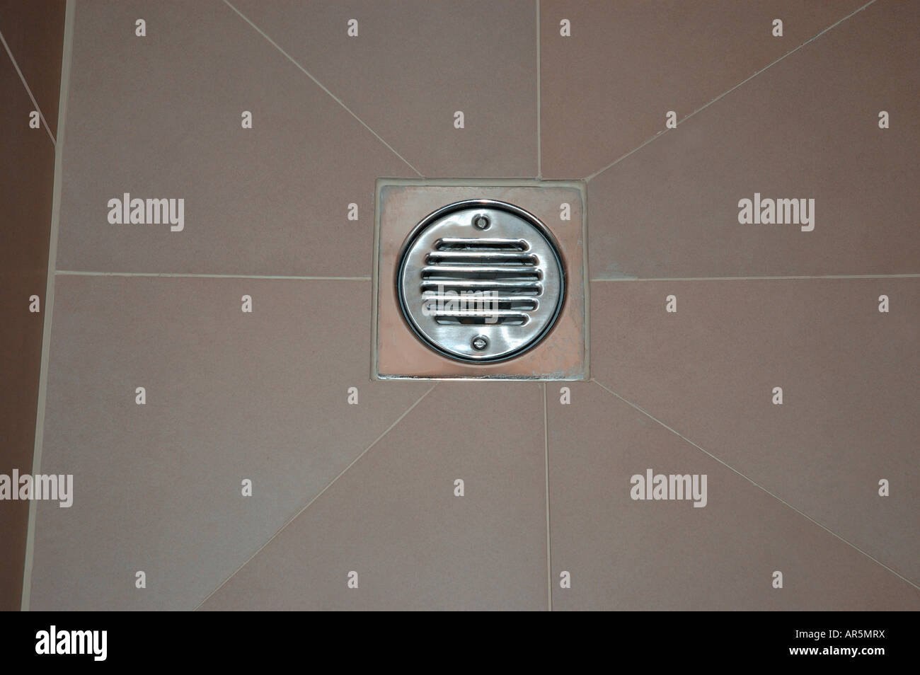 Close up of drain in bathroom floor Stock Photo - Alamy