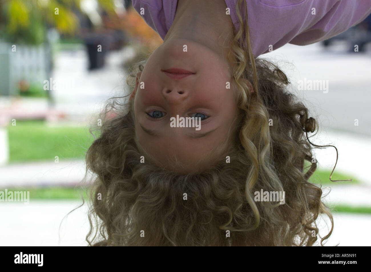 girl hanging upside down Stock Photo - Alamy