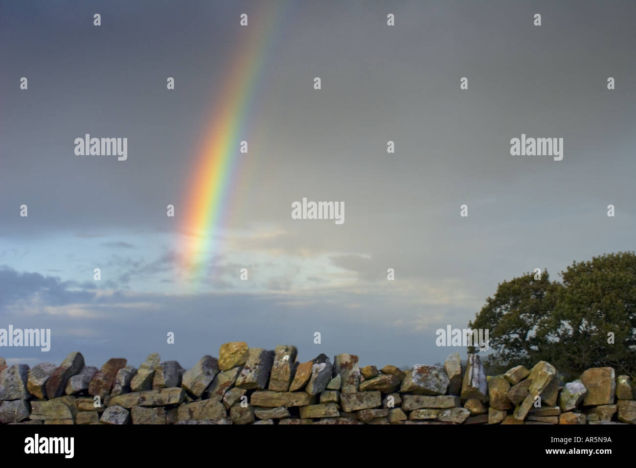 Rainbow and Stone Wall Stock Photo - Alamy