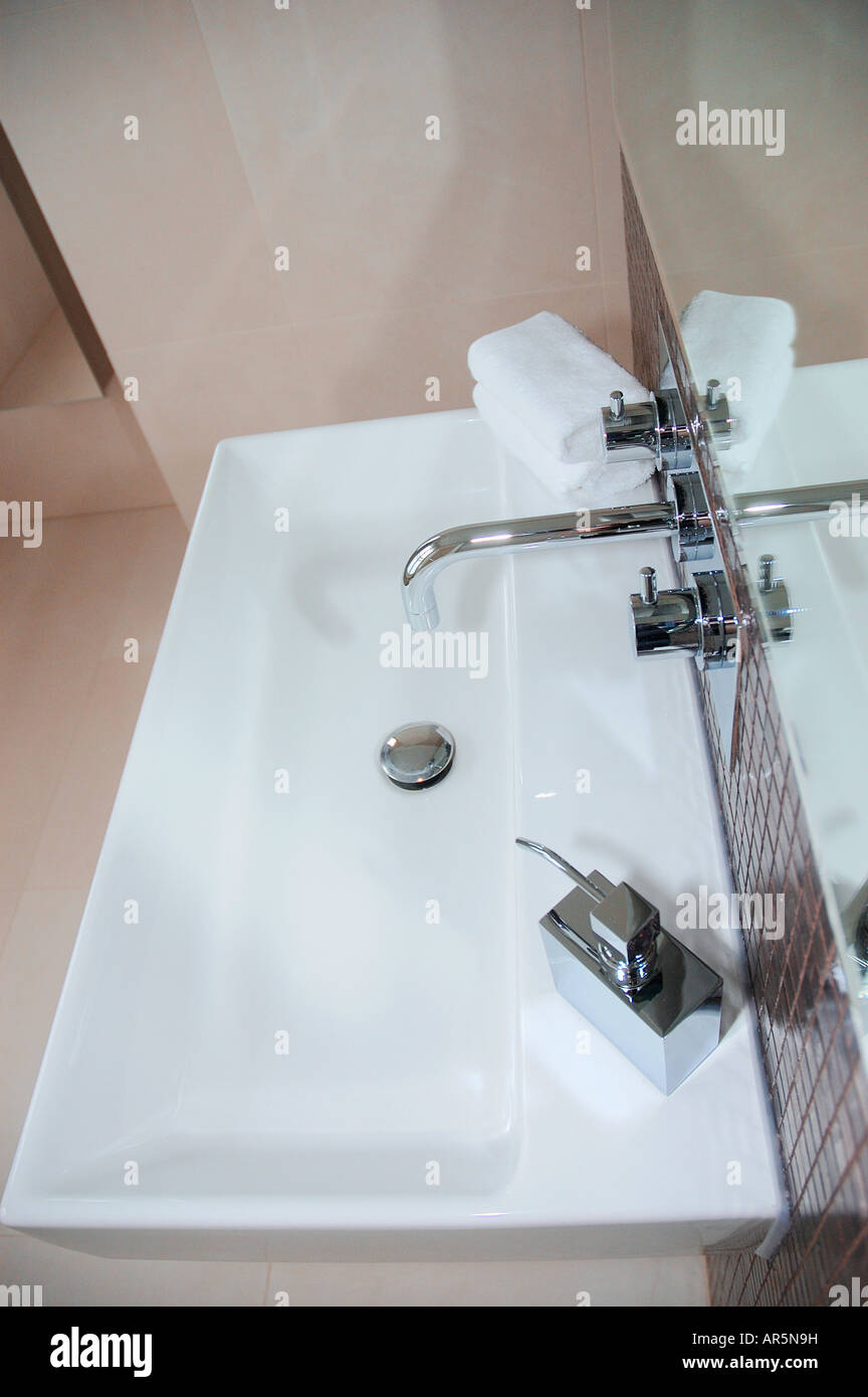 Aerial view of stainless steel tap and soap dispenser above rectangular ...