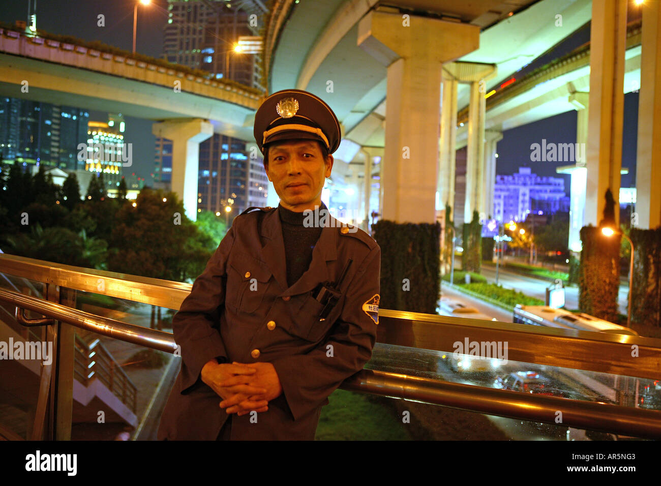 security guard, below elevated highway, Shanghai Stock Photo - Alamy