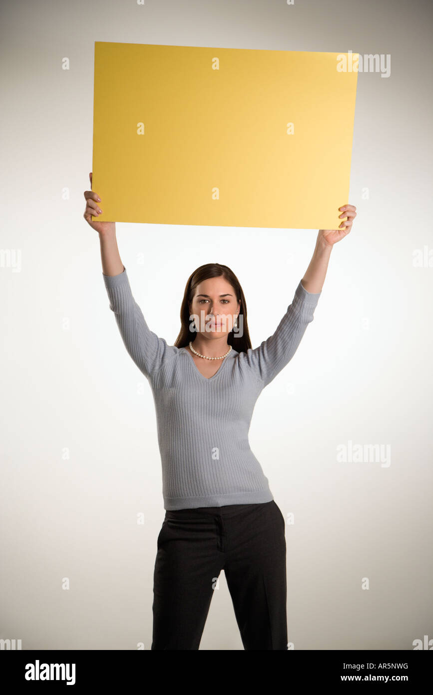 Caucasian mid adult professional business woman standing holding up ...