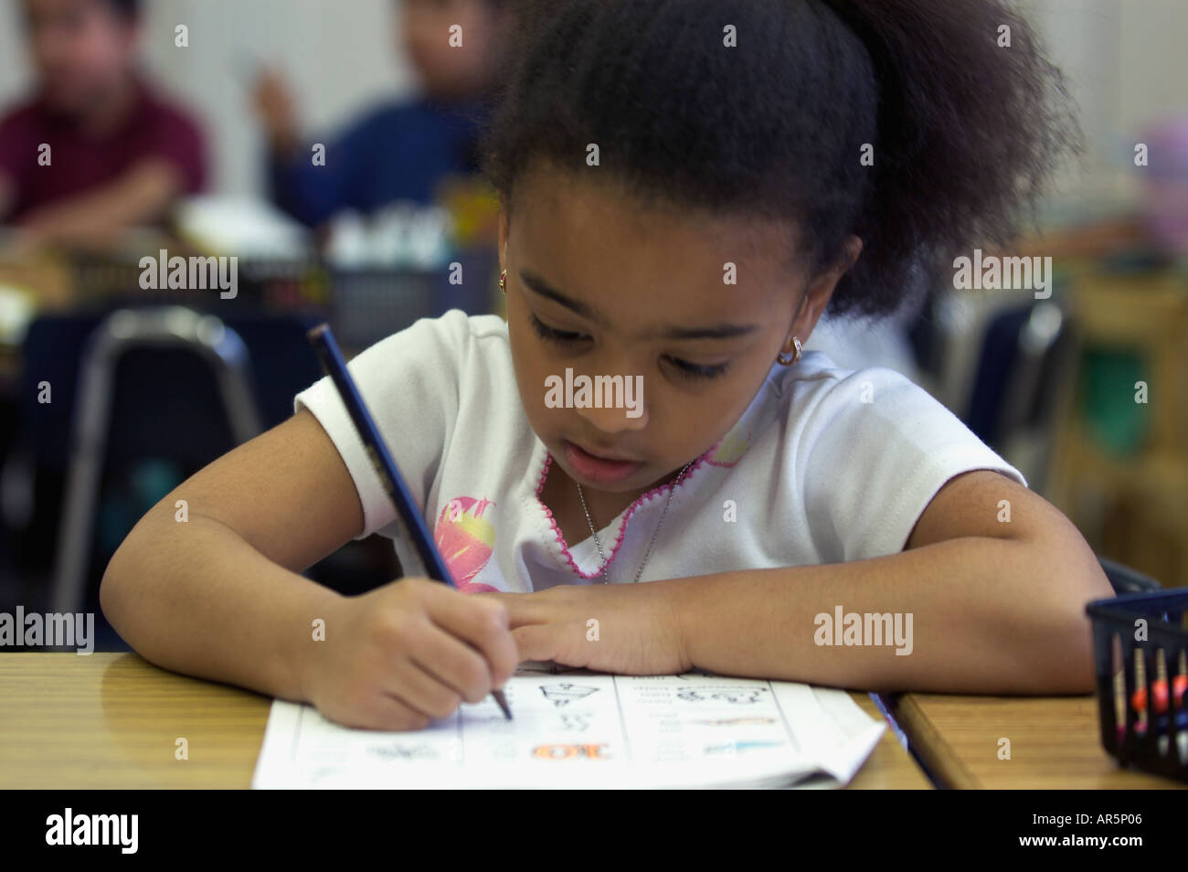 young student writing in class Stock Photo - Alamy