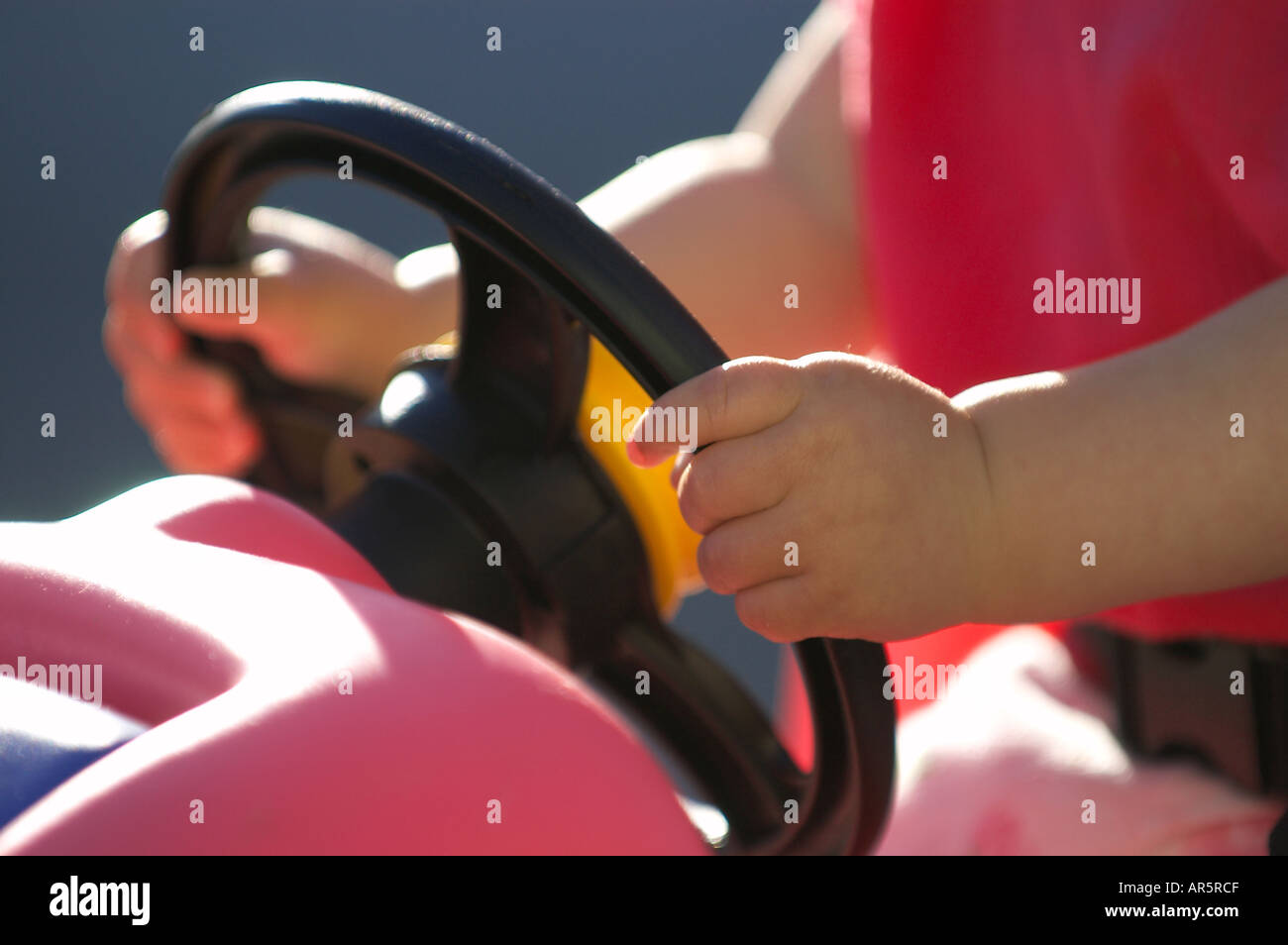 baby with toy car stearing wheel Stock Photo - Alamy