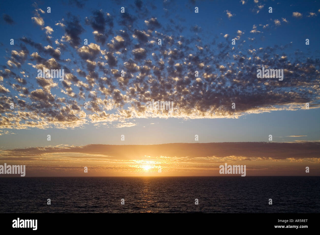 Sunset over ocean Stock Photo - Alamy