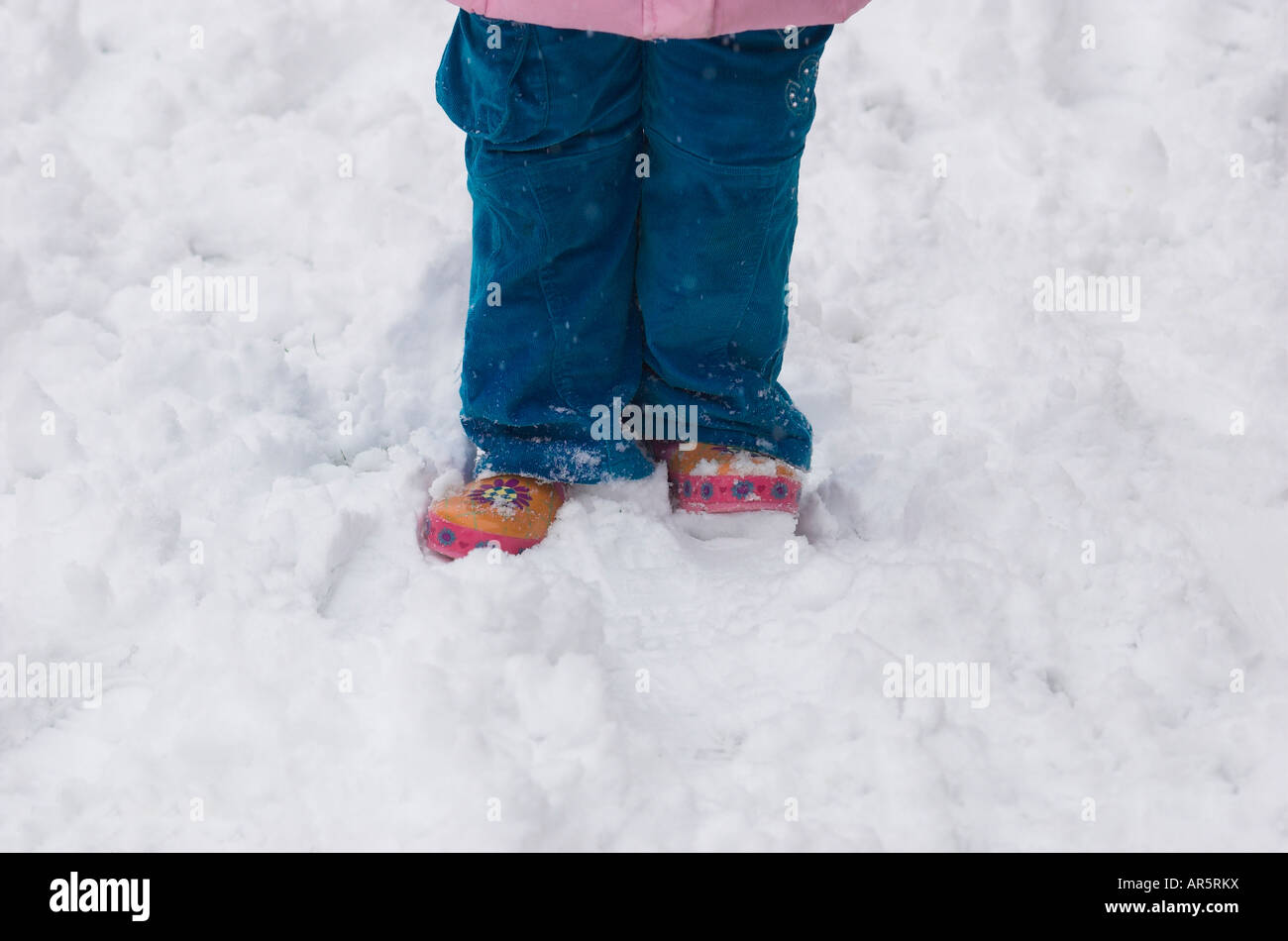 Girl standing in snow low section view Stock Photo - Alamy