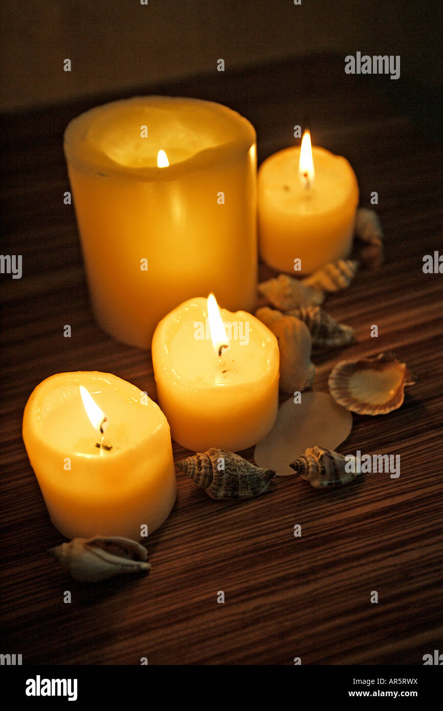 Burning candles and seashells Stock Photo - Alamy